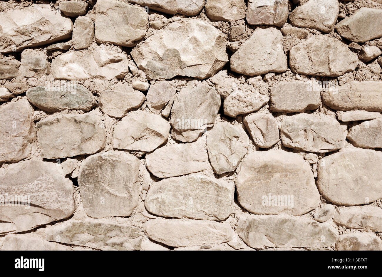 Old rough stone wall, background wallpaper Stock Photo - Alamy