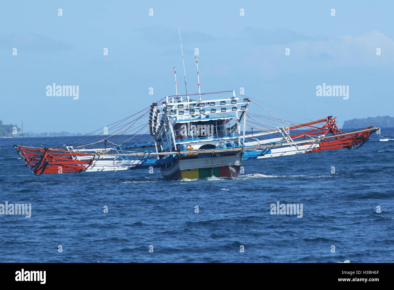 Large fishing boat with wing-like extensions Stock Photo - Alamy
