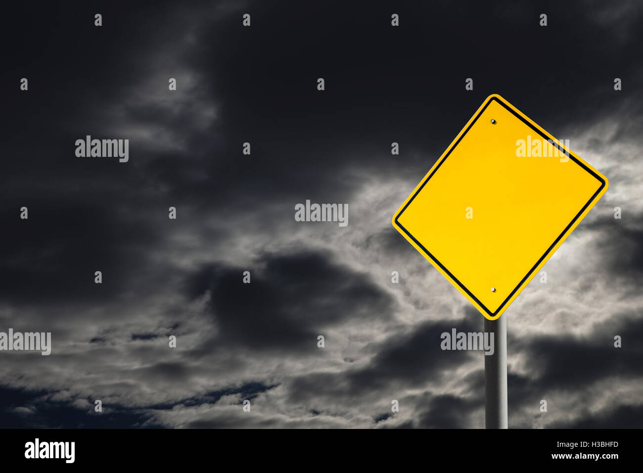 An empty traffic sign against a dark cloudy sky. Conceptually warning ...