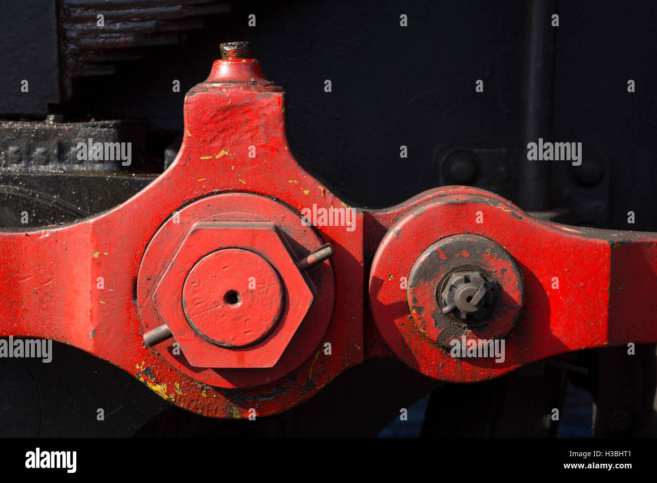 Mechanical Parts. Red driving rod with large central nut and cotter pin ...