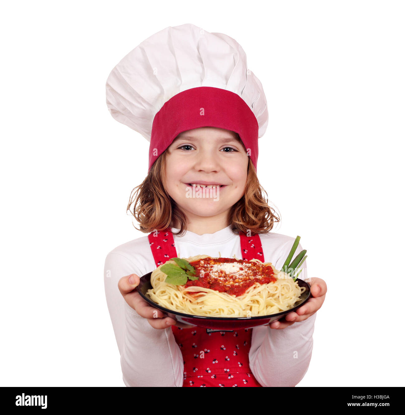 happy little girl cook holding dish with spaghetti Stock Photo - Alamy