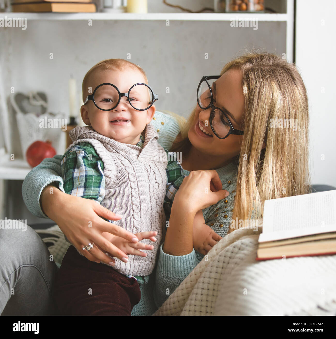 Mother and her son reading book at home Stock Photo - Alamy