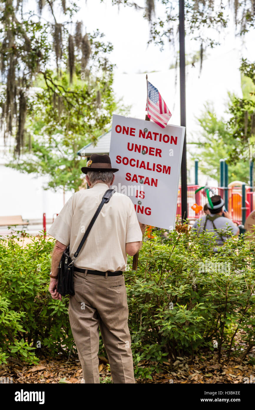 Old Man carrying sign Satan is Coming Stock Photo - Alamy