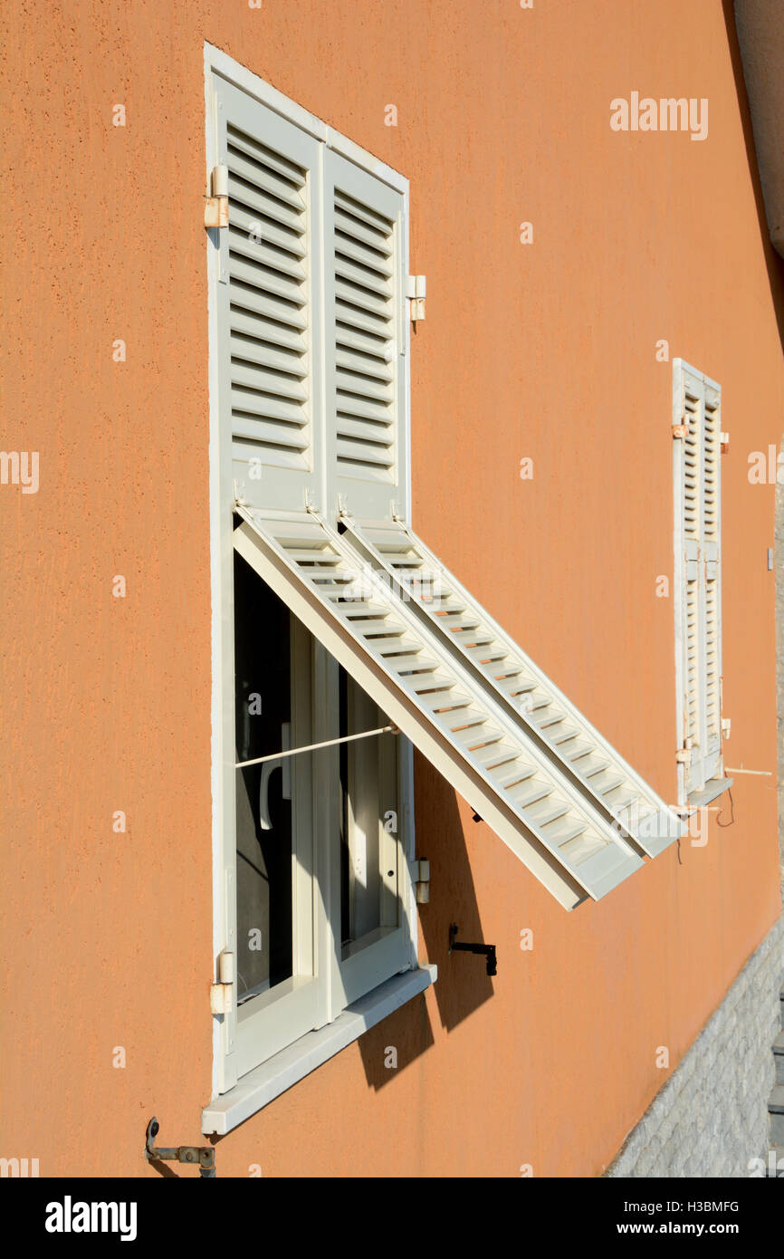 Half open white window shutters Stock Photo - Alamy