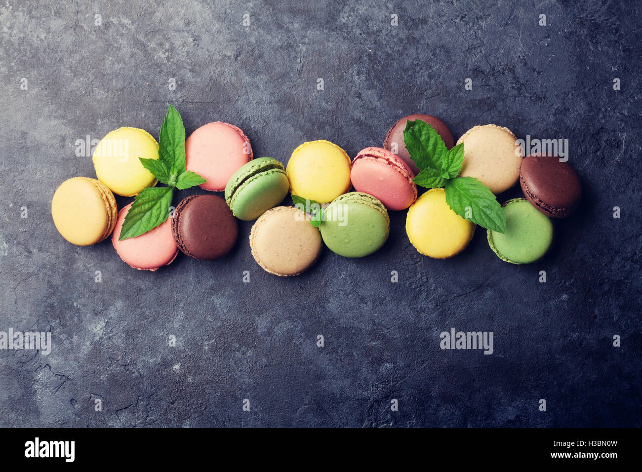 Colorful macaroons on stone table. Sweet macarons. Top view with copy ...