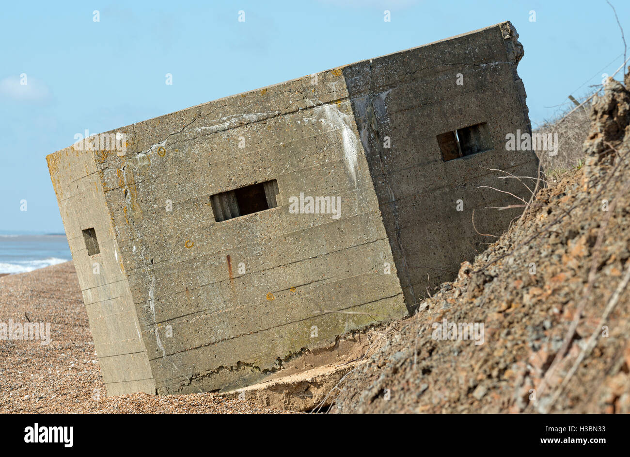WW2 pillbox which due to coastal erosion has falling from a clifftop ...
