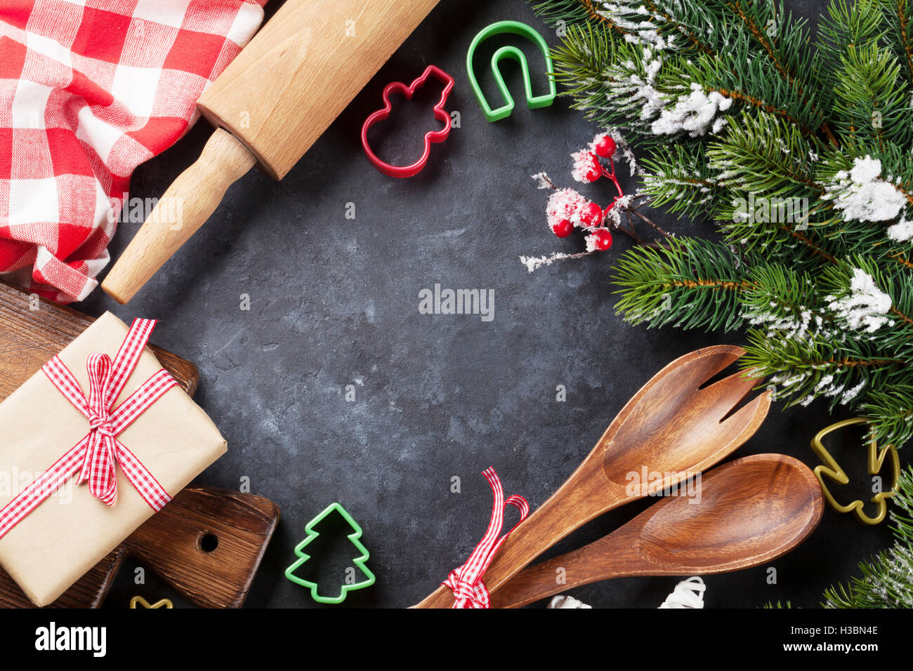 Christmas cooking utensils and snow tree on stone table. Top view with ...