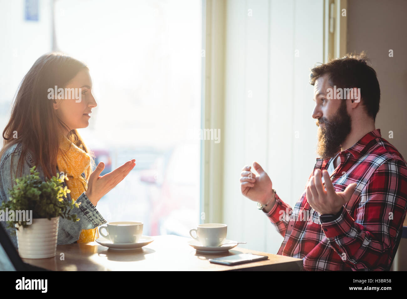 Man and woman talking at cafe Stock Photo - Alamy