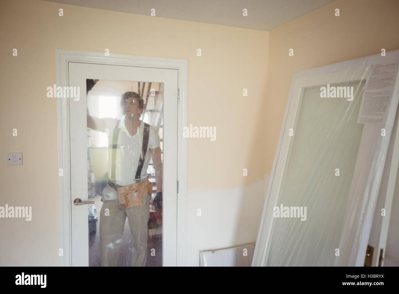 Carpenter Fixing A Door Stock Photo Alamy