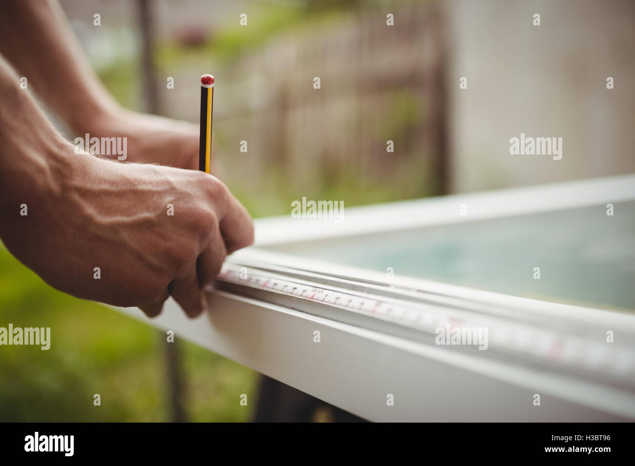 carpenter's hands measuring a door frame Stock Photo - Alamy