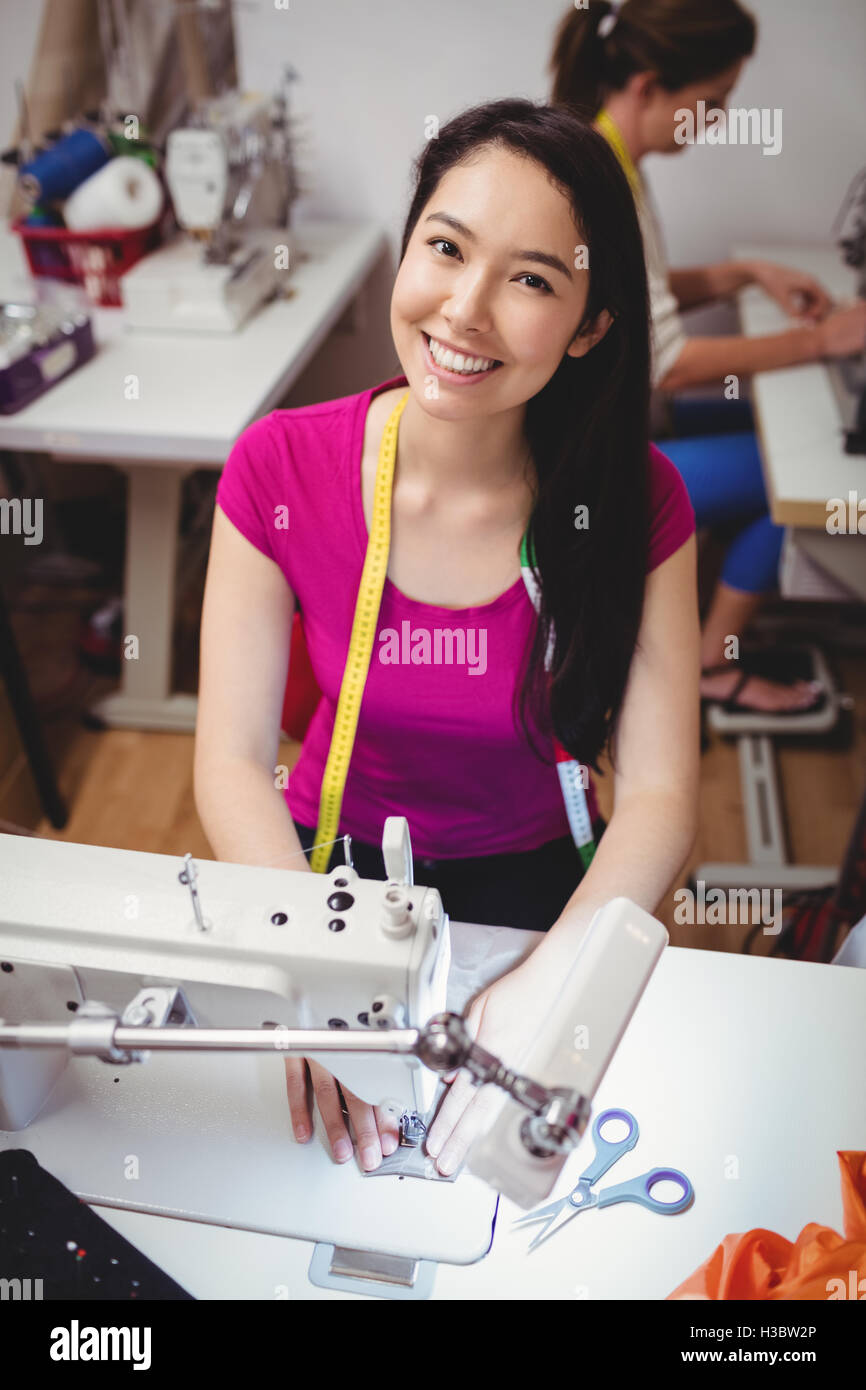 Female dressmaker sewing in the studio Stock Photo - Alamy