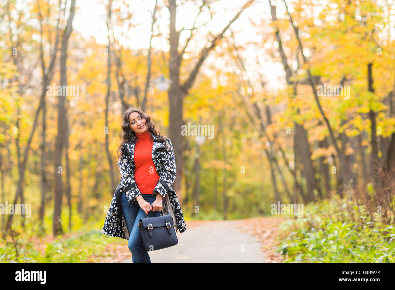 Pretty young student girl in autumn outdoor Stock Photo - Alamy