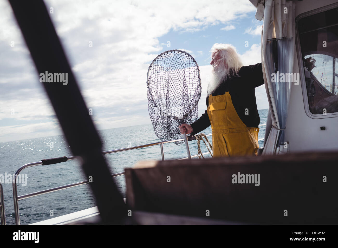 Fisherman holding fishing net Stock Photo - Alamy