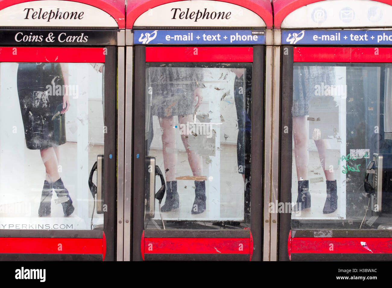 A telephone call box with adverts on windows Stock Photo - Alamy