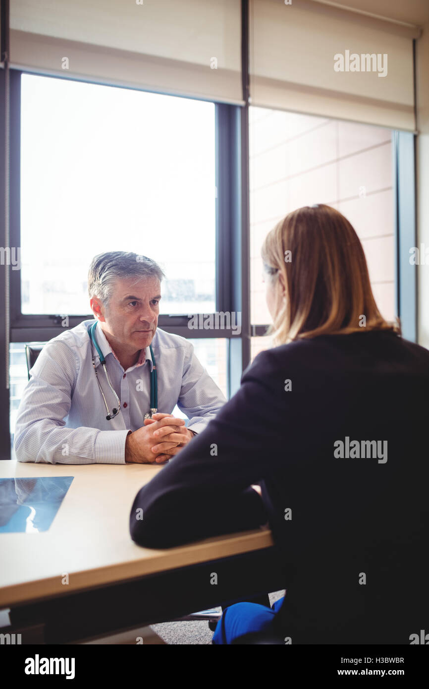 Doctor sitting at his desk hi-res stock photography and images - Alamy