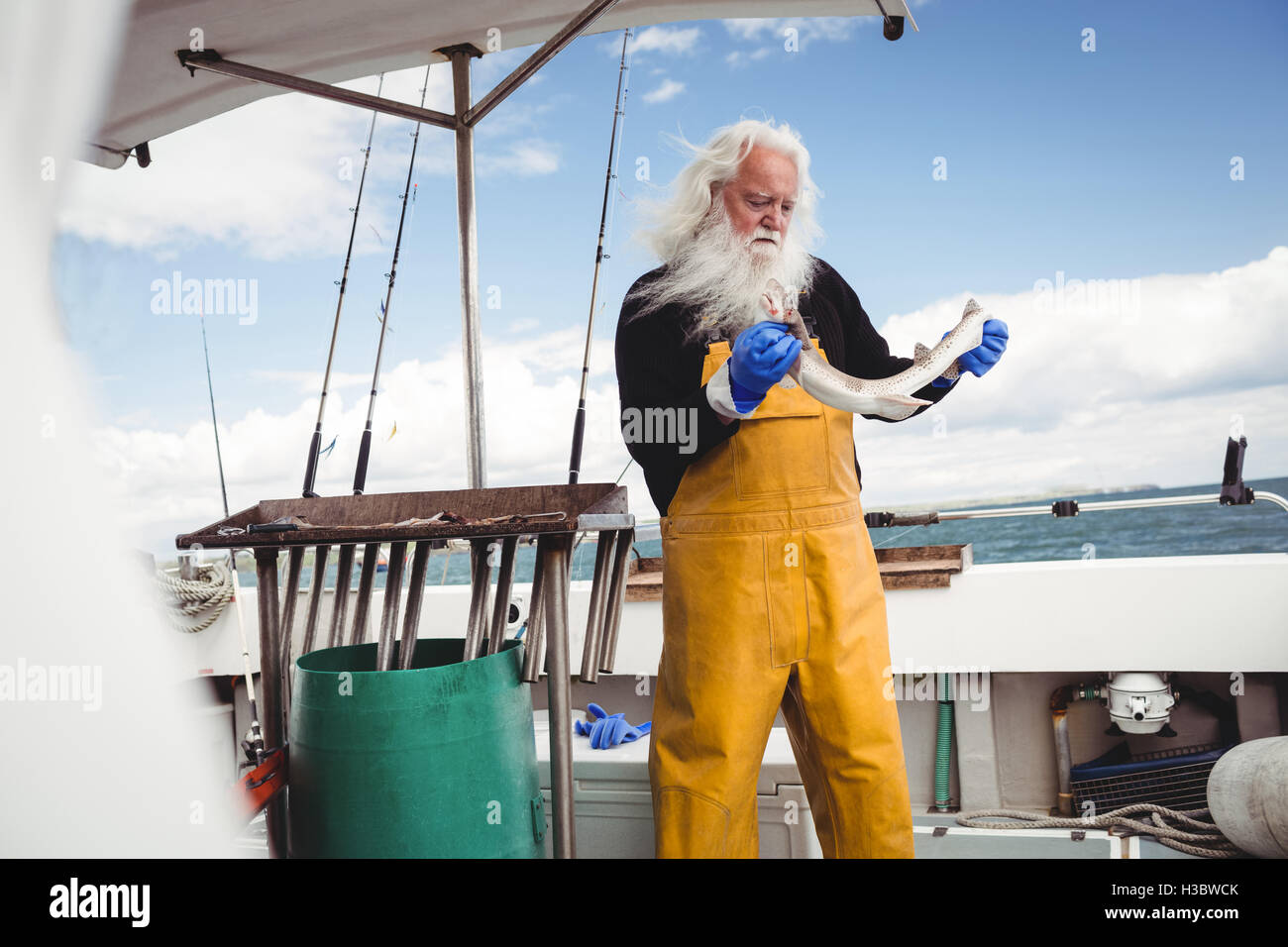 Fisherman holding fish Stock Photo - Alamy