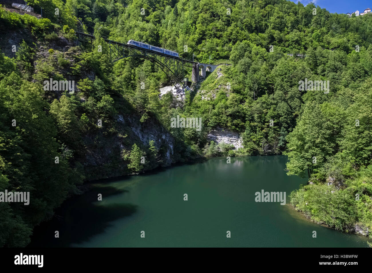 Vigezzina train on a bridge over the river Melezza. Borgnone, Canton ...
