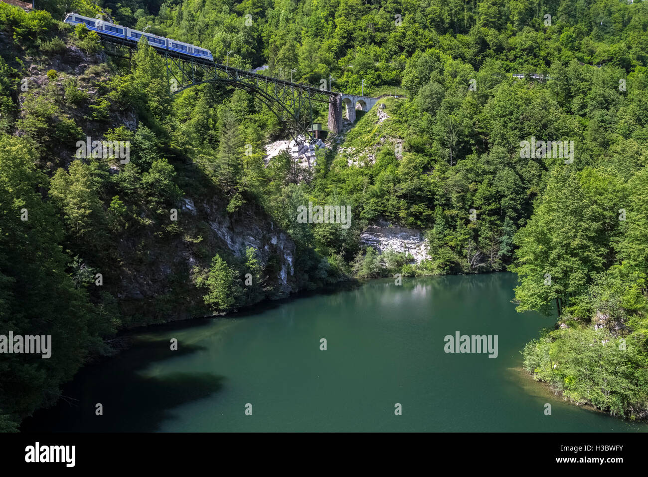 Vigezzina train on a bridge over the river Melezza. Borgnone, Canton ...