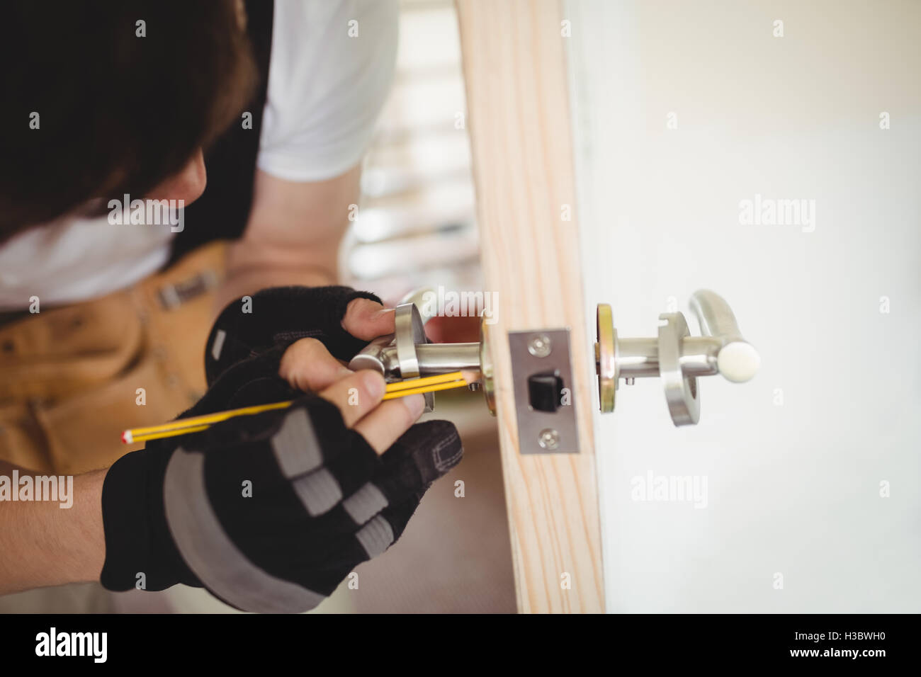 Carpenter fixing door lock Stock Photo - Alamy Carpenter fixing door lock Stock Photo - Alamy
