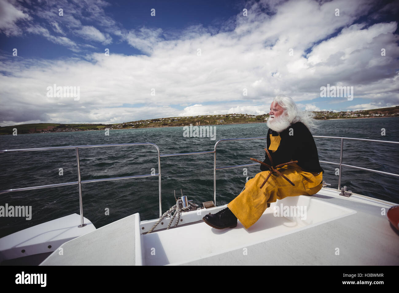 Fisherman sitting on fishing boat Stock Photo - Alamy