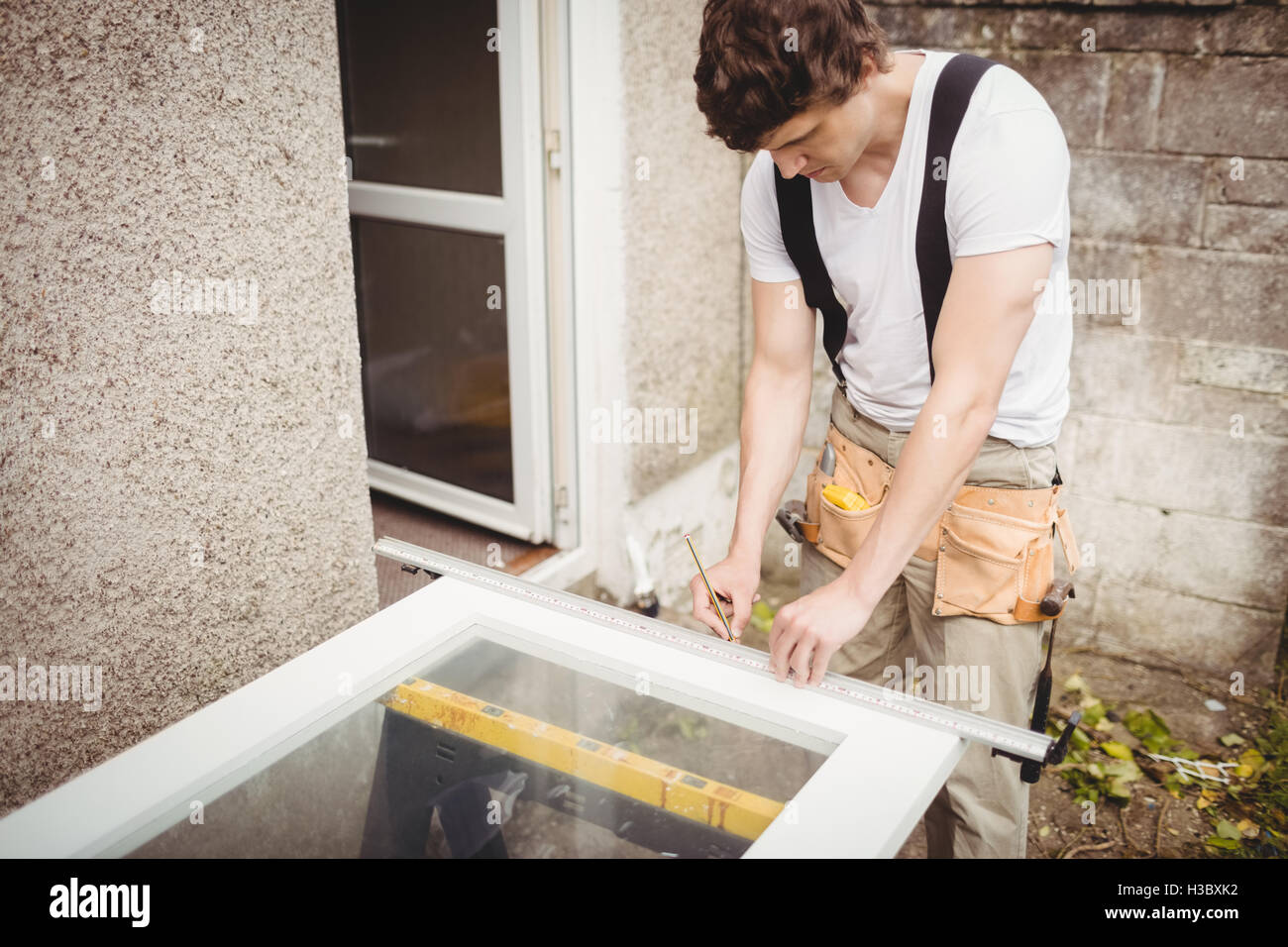 carpenters hands measuring a door frame Stock Photo - Alamy