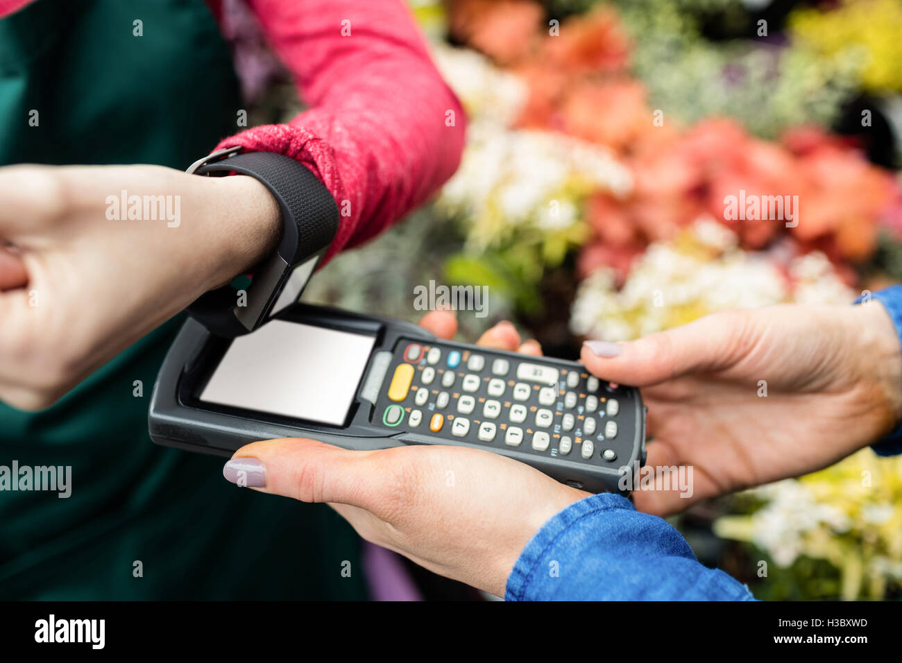 Woman making payment through smart watch Stock Photo - Alamy