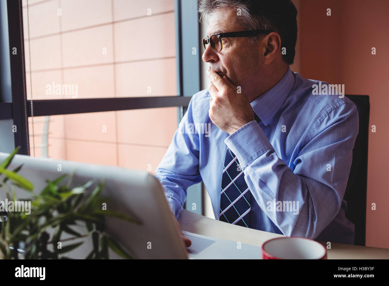 Worried man sitting desk laptop hi-res stock photography and images - Alamy