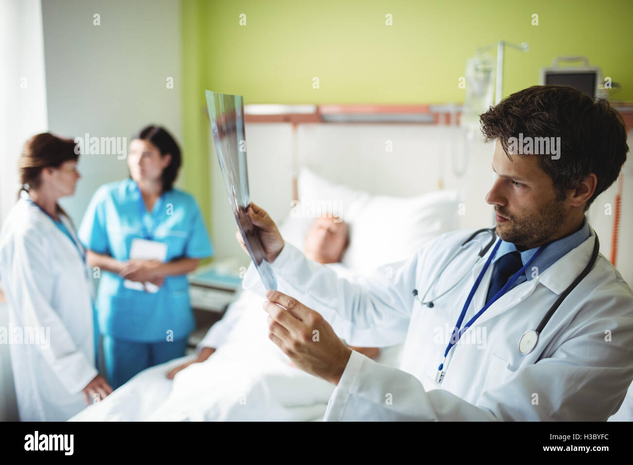 Doctor checking x-ray report Stock Photo - Alamy