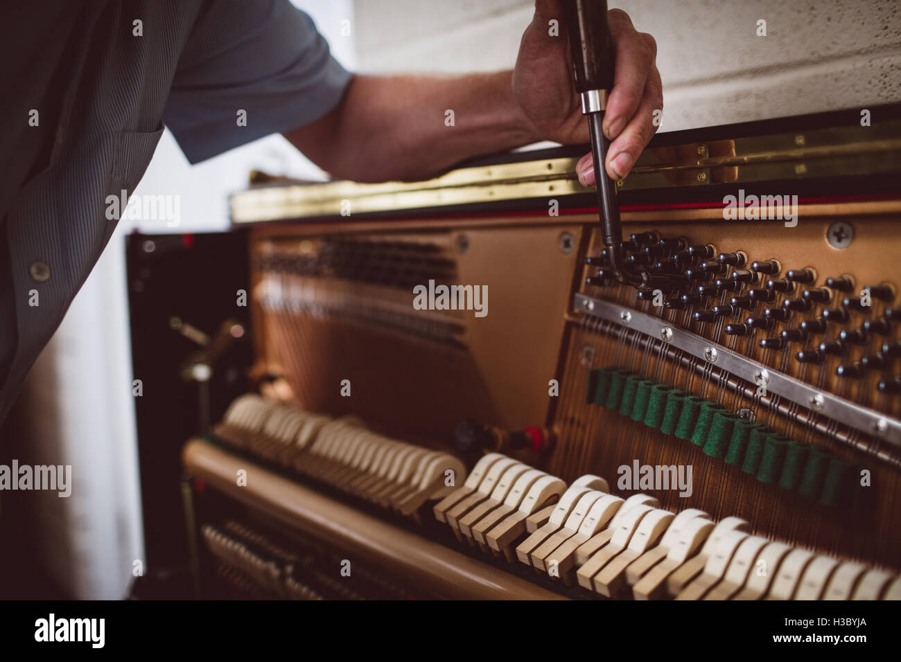 Piano technician repairing the piano Stock Photo - Alamy
