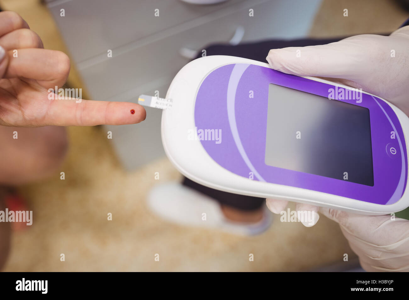 Doctor measuring sugar level of patient with glucometer Stock Photo - Alamy