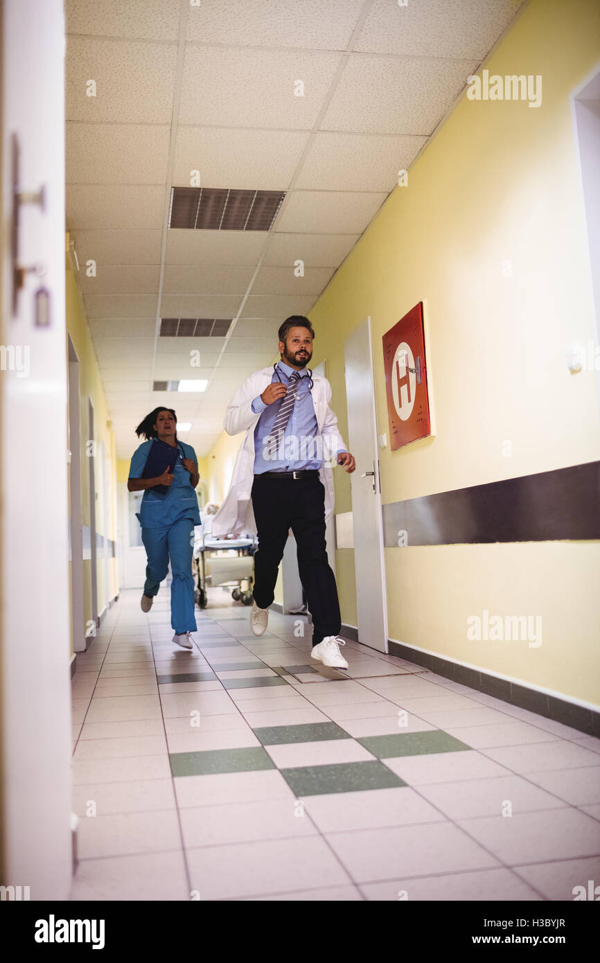 Doctor and nurse running in hospital corridor Stock Photo - Alamy