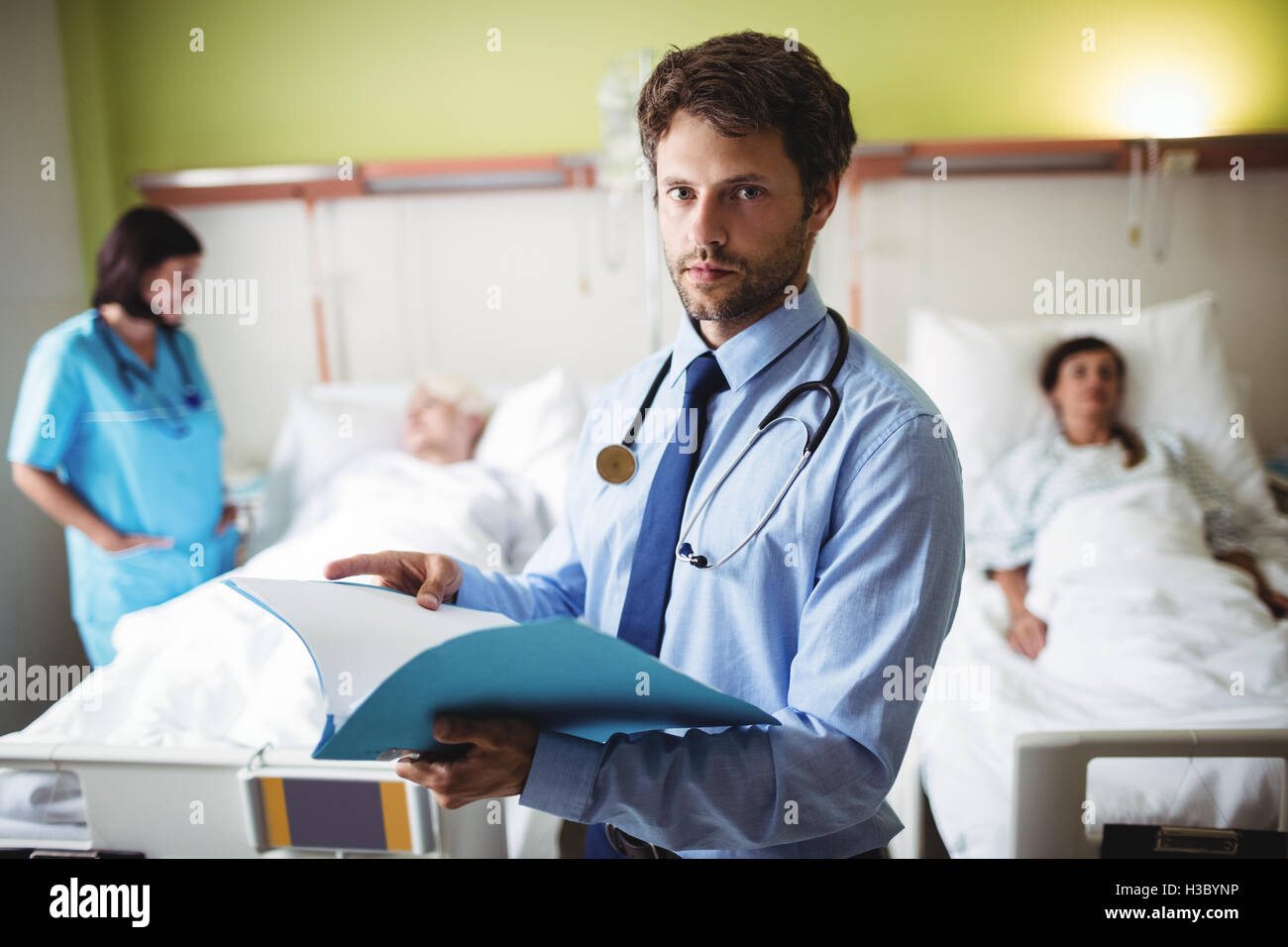 Portrait of doctor checking report Stock Photo - Alamy