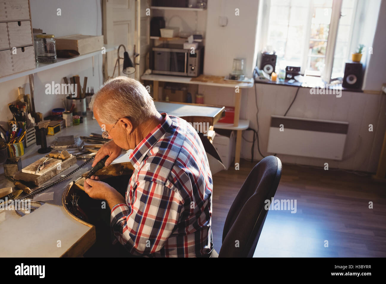 Goldsmith using hand piece machine Stock Photo - Alamy