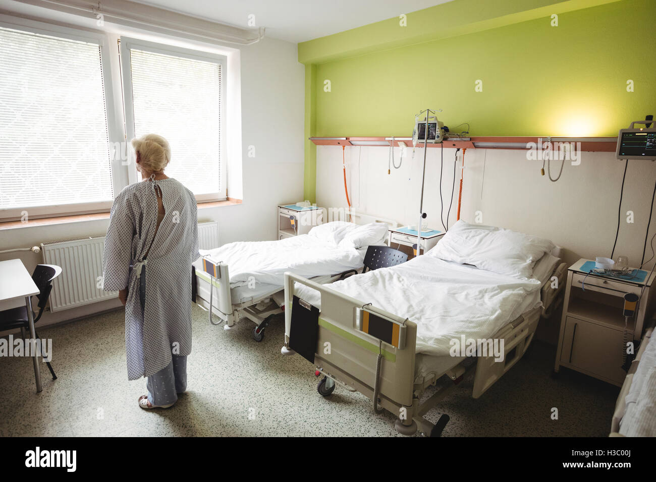 Senior woman standing in ward Stock Photo - Alamy