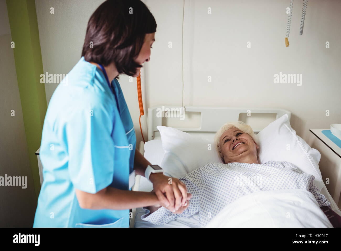 Nurse consoling senior patient Stock Photo - Alamy