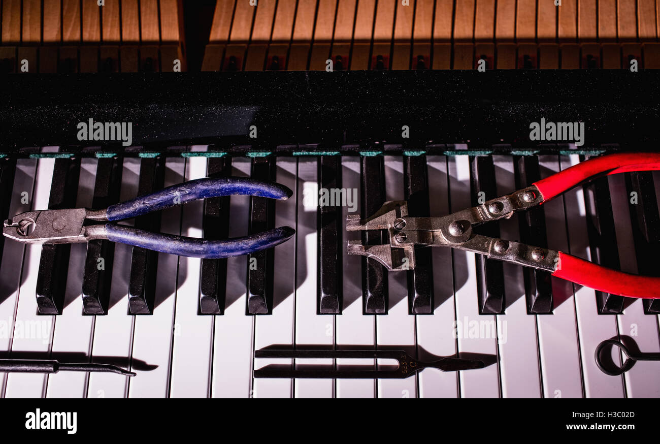 Repairing tools kept on old piano keyboard Stock Photo - Alamy