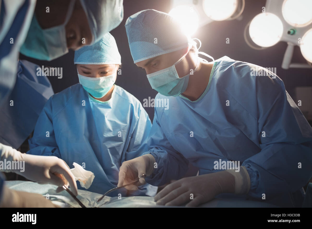 Surgeons performing operation in operation room Stock Photo - Alamy