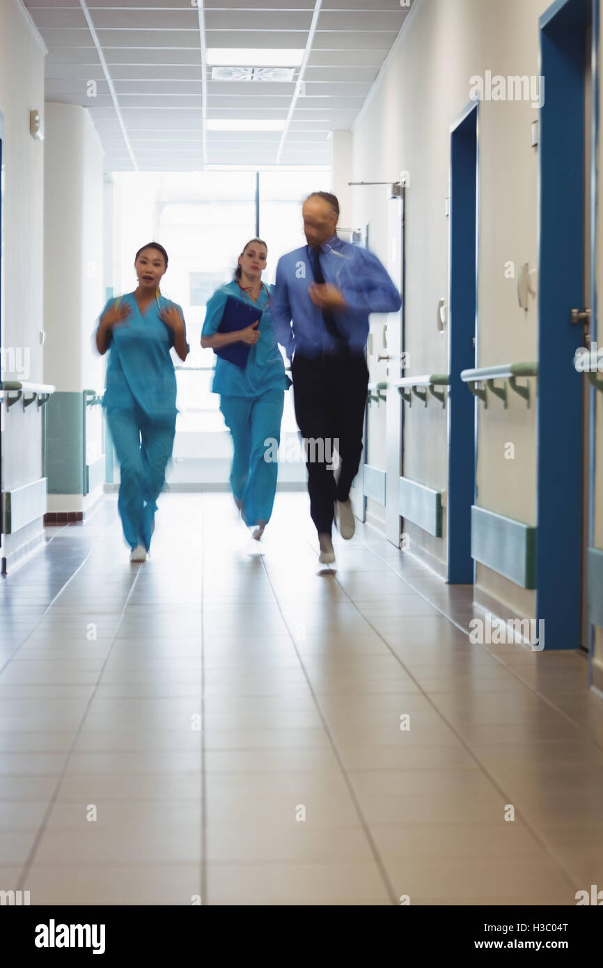 Doctor and nurse running in passageway of hospital Stock Photo - Alamy