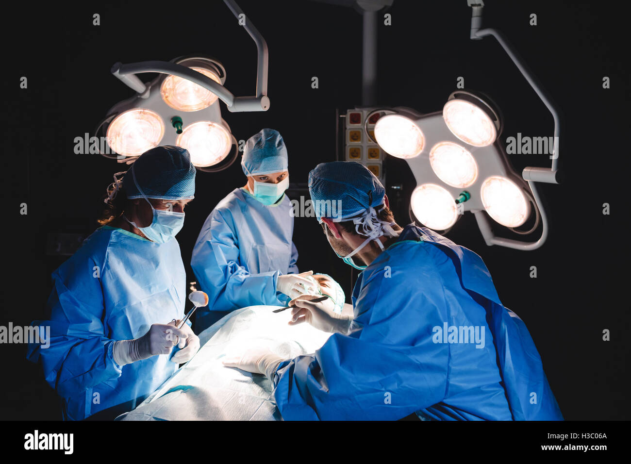 Elderly doctor performing surgery hi-res stock photography and images ...