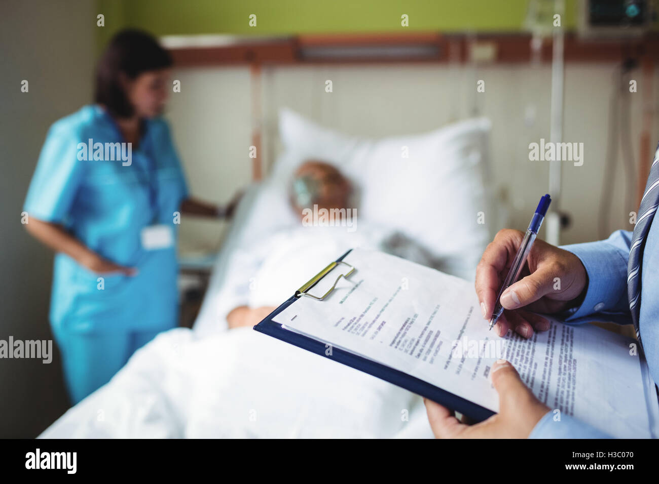 Hands of male doctor preparing medical report Stock Photo - Alamy