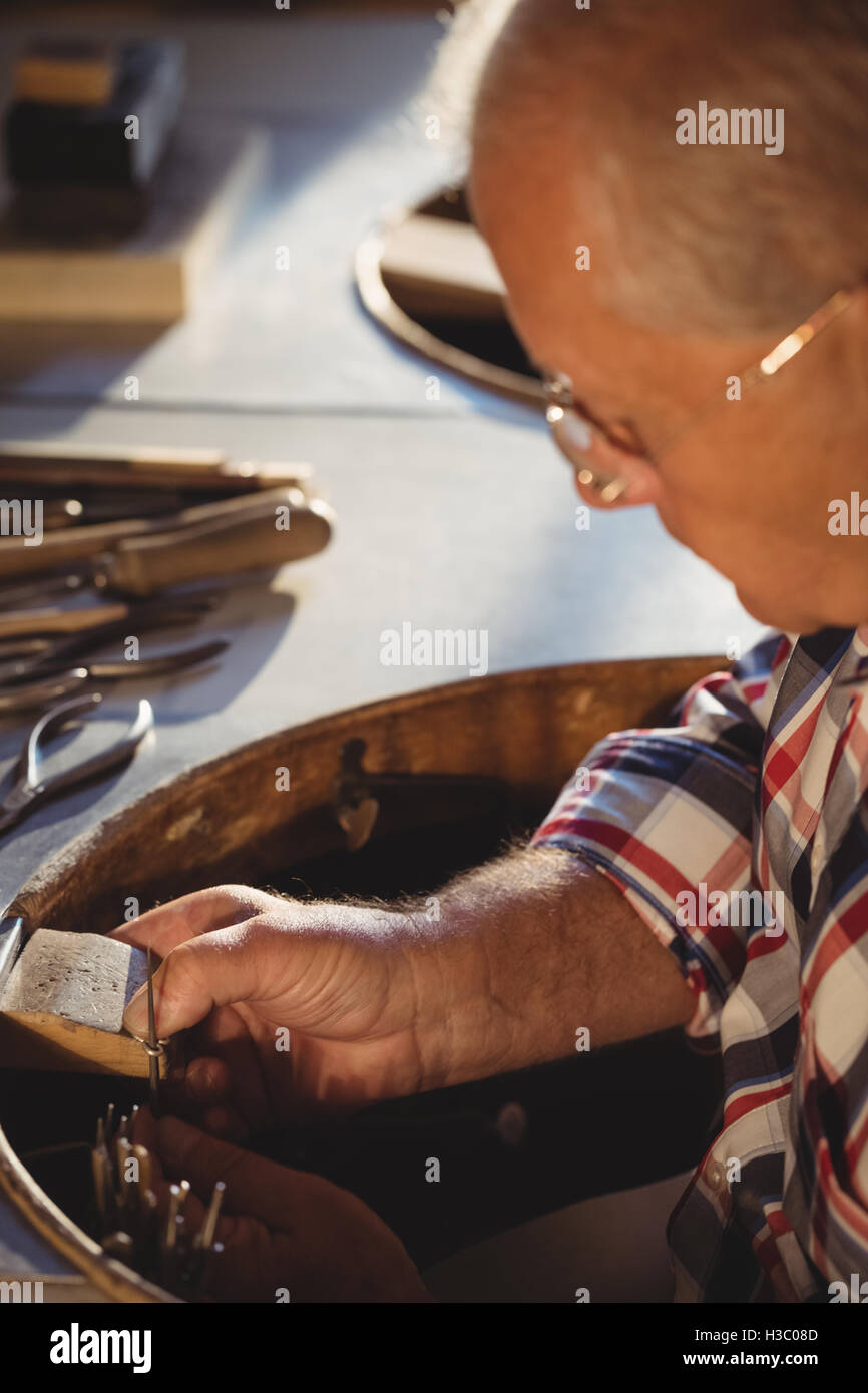Goldsmith working in workshop Stock Photo - Alamy
