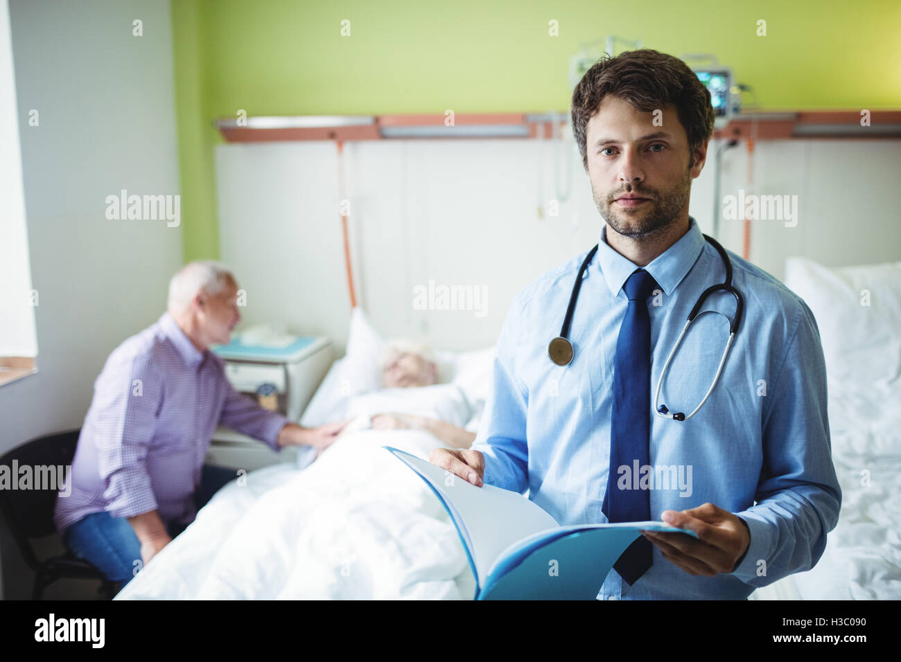Doctor checking a report Stock Photo - Alamy