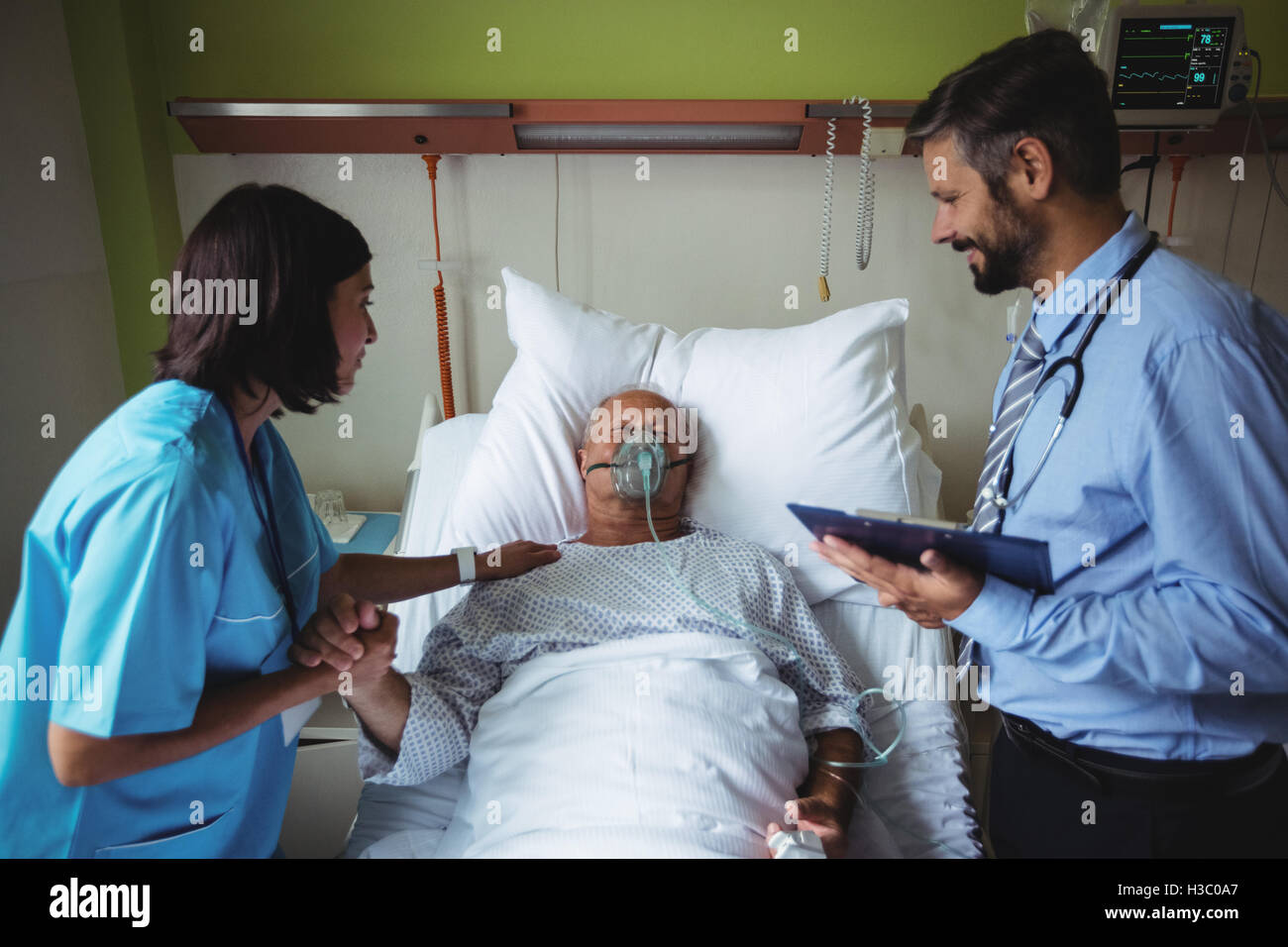 Nurse consoling senior patient with doctor Stock Photo - Alamy