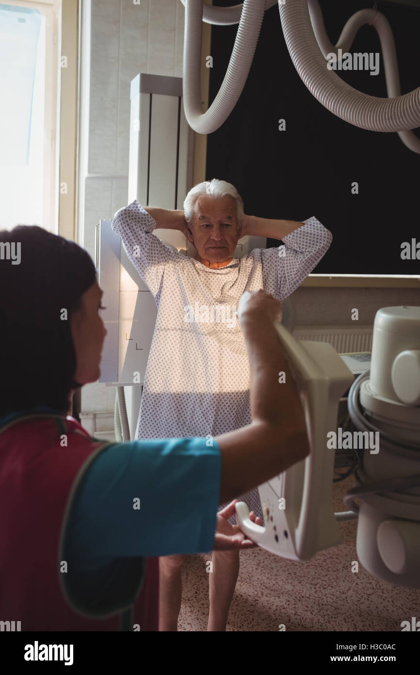 Female doctor sets up the machine to x-ray a patients chest Stock Photo ...