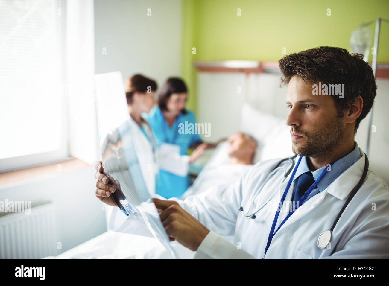 Doctor checking x-ray report Stock Photo - Alamy