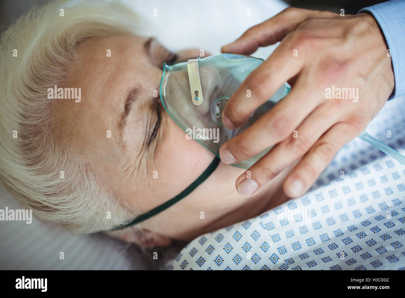 Doctor putting oxygen mask on patient Stock Photo - Alamy