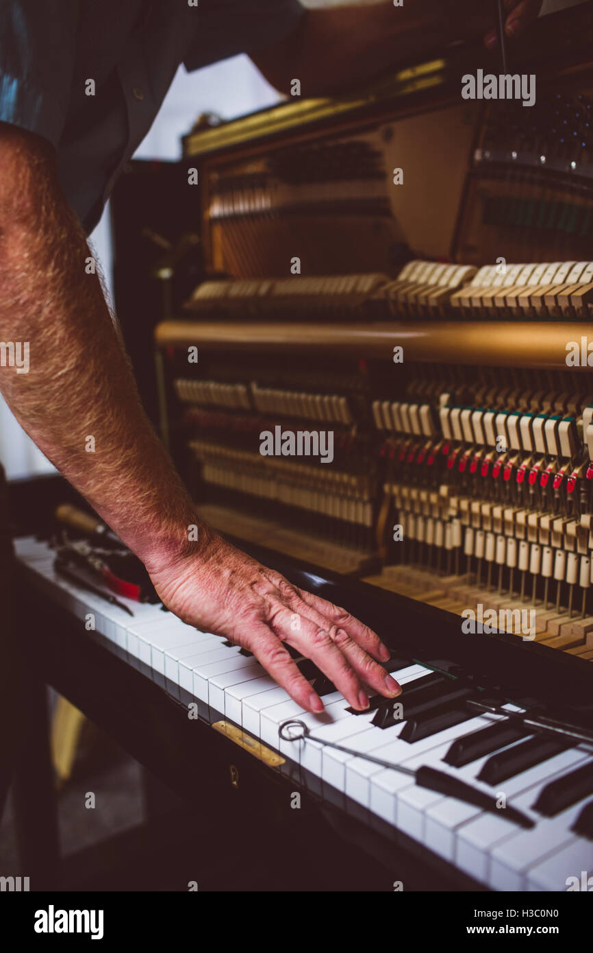 Piano technician repairing the piano Stock Photo - Alamy