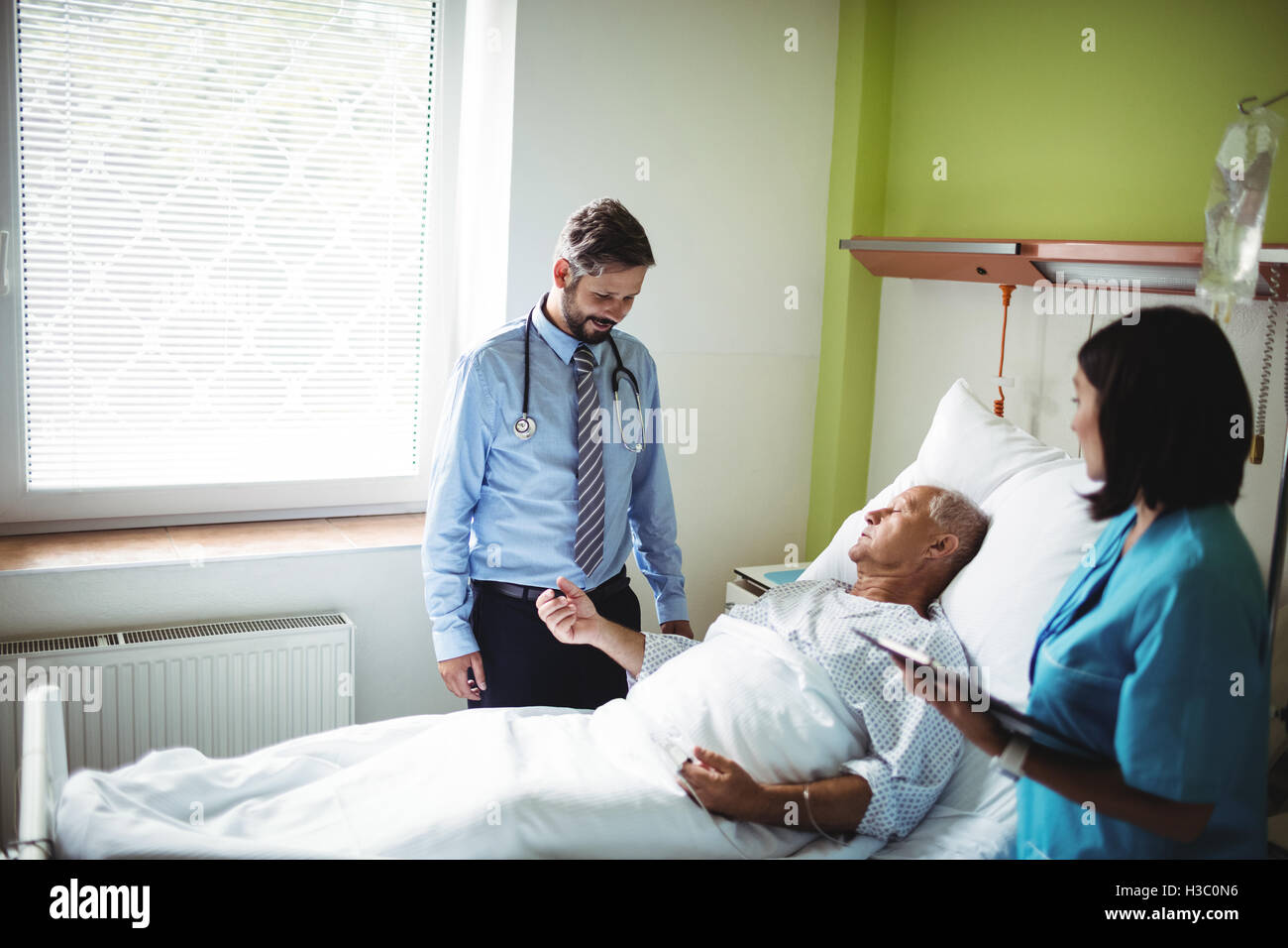 Doctor and nurse interacting with patient Stock Photo - Alamy