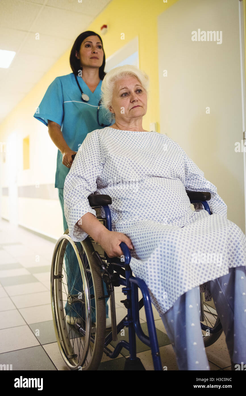 Nurse pushing a senior patient on a wheelchair Stock Photo - Alamy