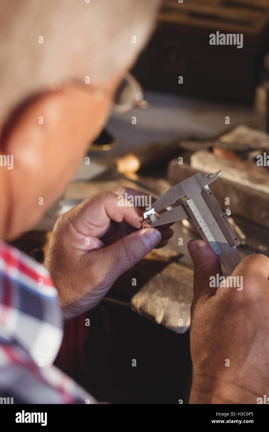 Goldsmith manufacturing ring Stock Photo - Alamy